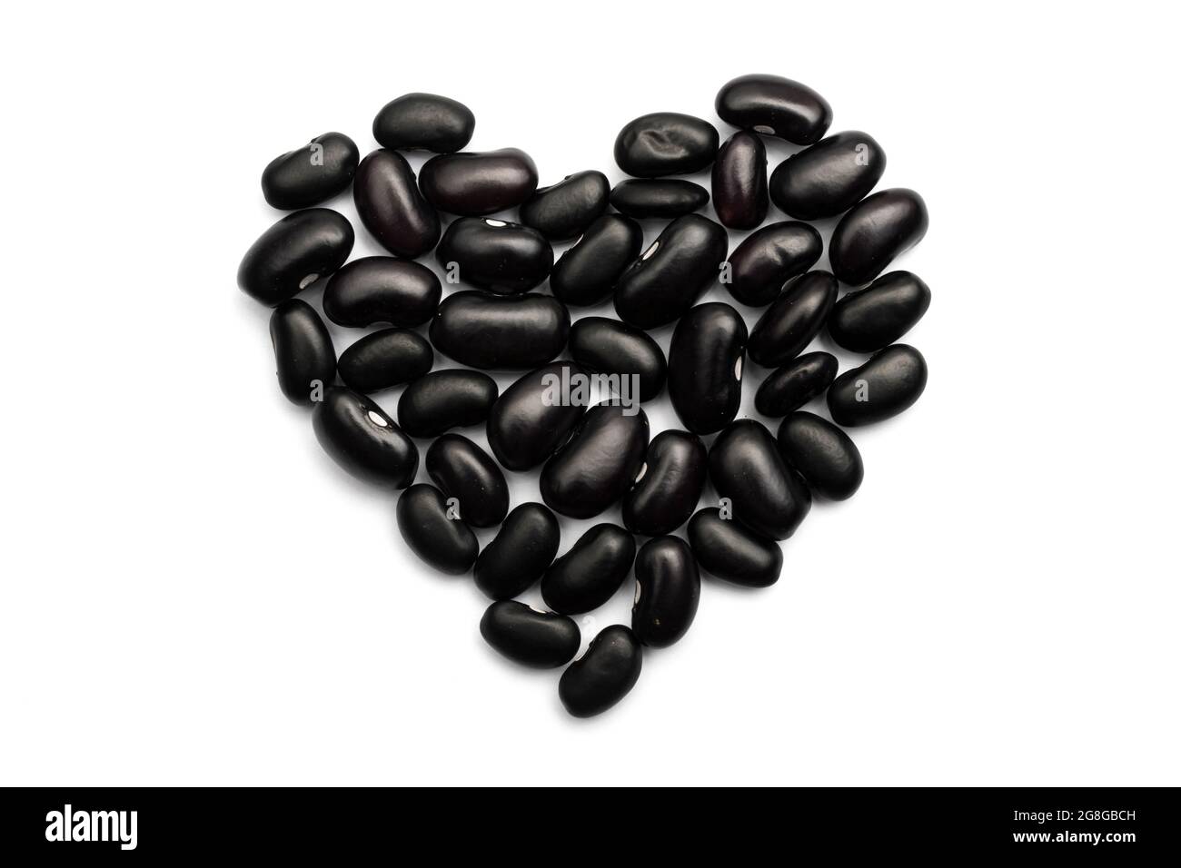 Heart shape made with black caribbean beans isolated on white ...