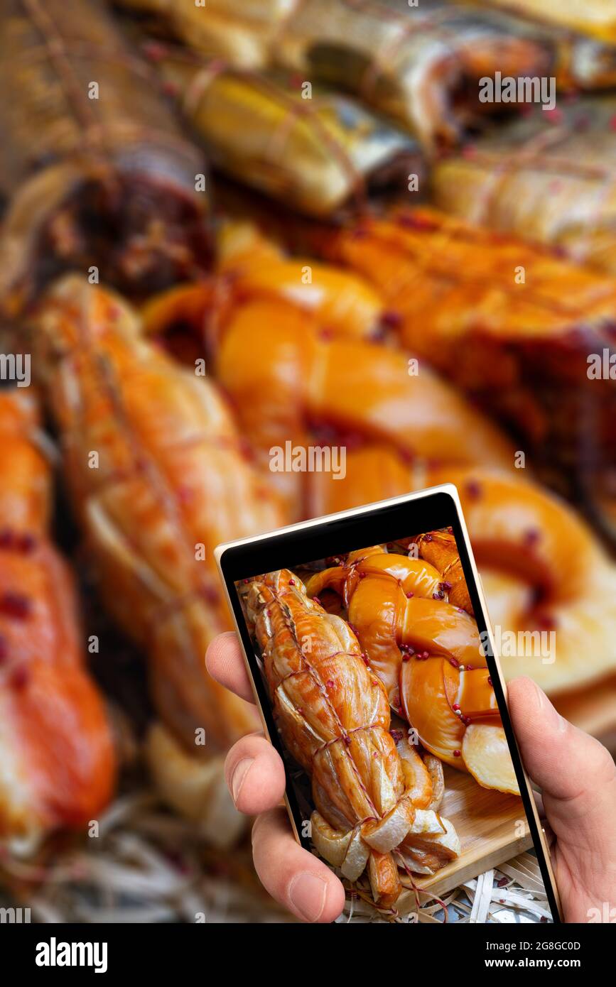 Smoked fish on a smartphone screen Stock Photo - Alamy