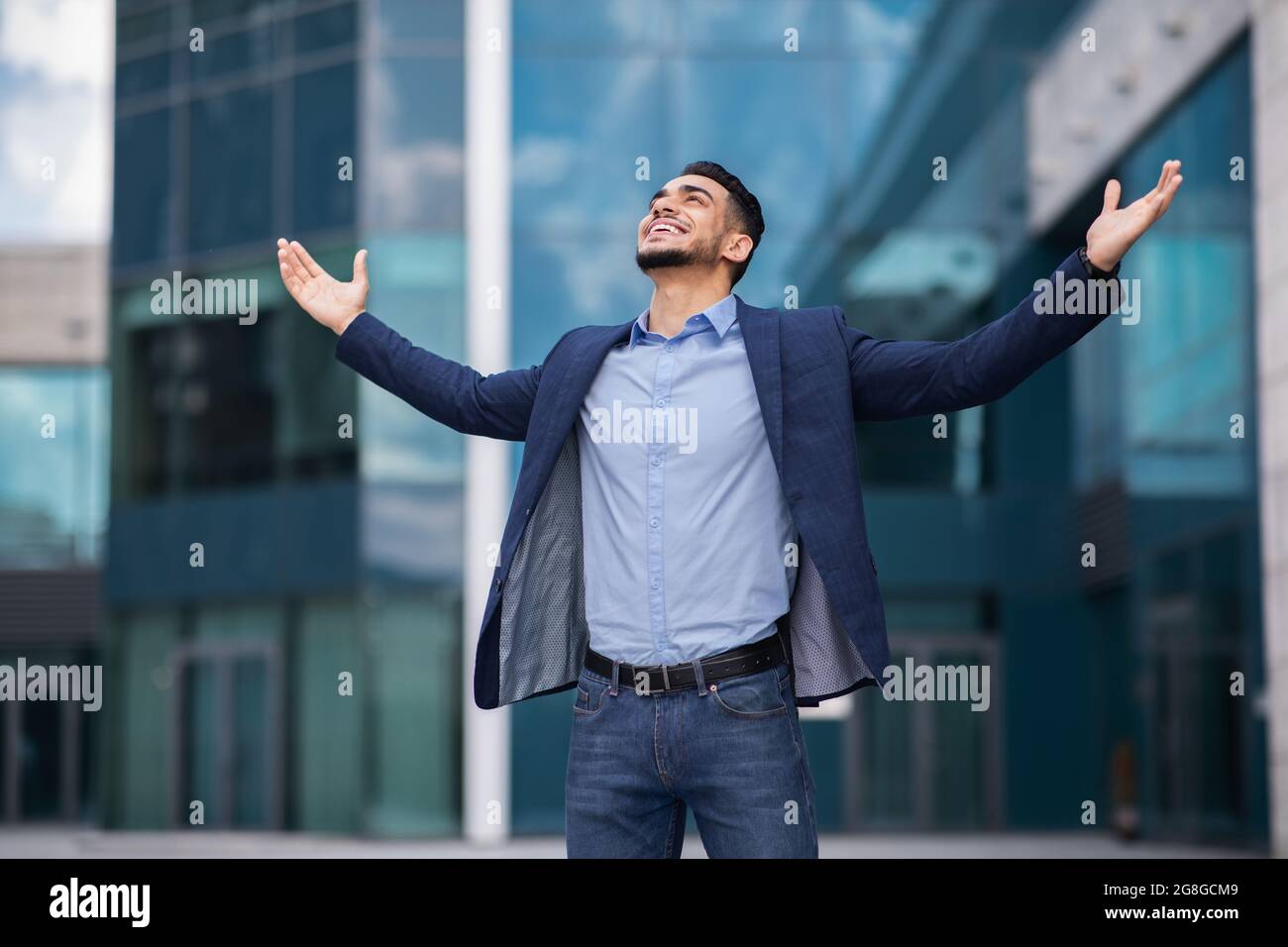 Millennial man raising hands hi-res stock photography and images - Alamy