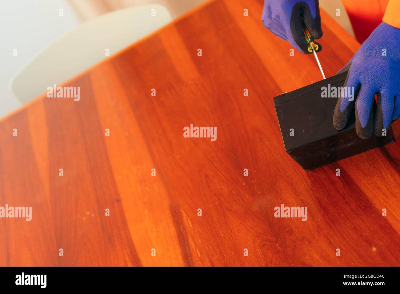 Hand of a man repairing a battery at home Stock Photo - Alamy