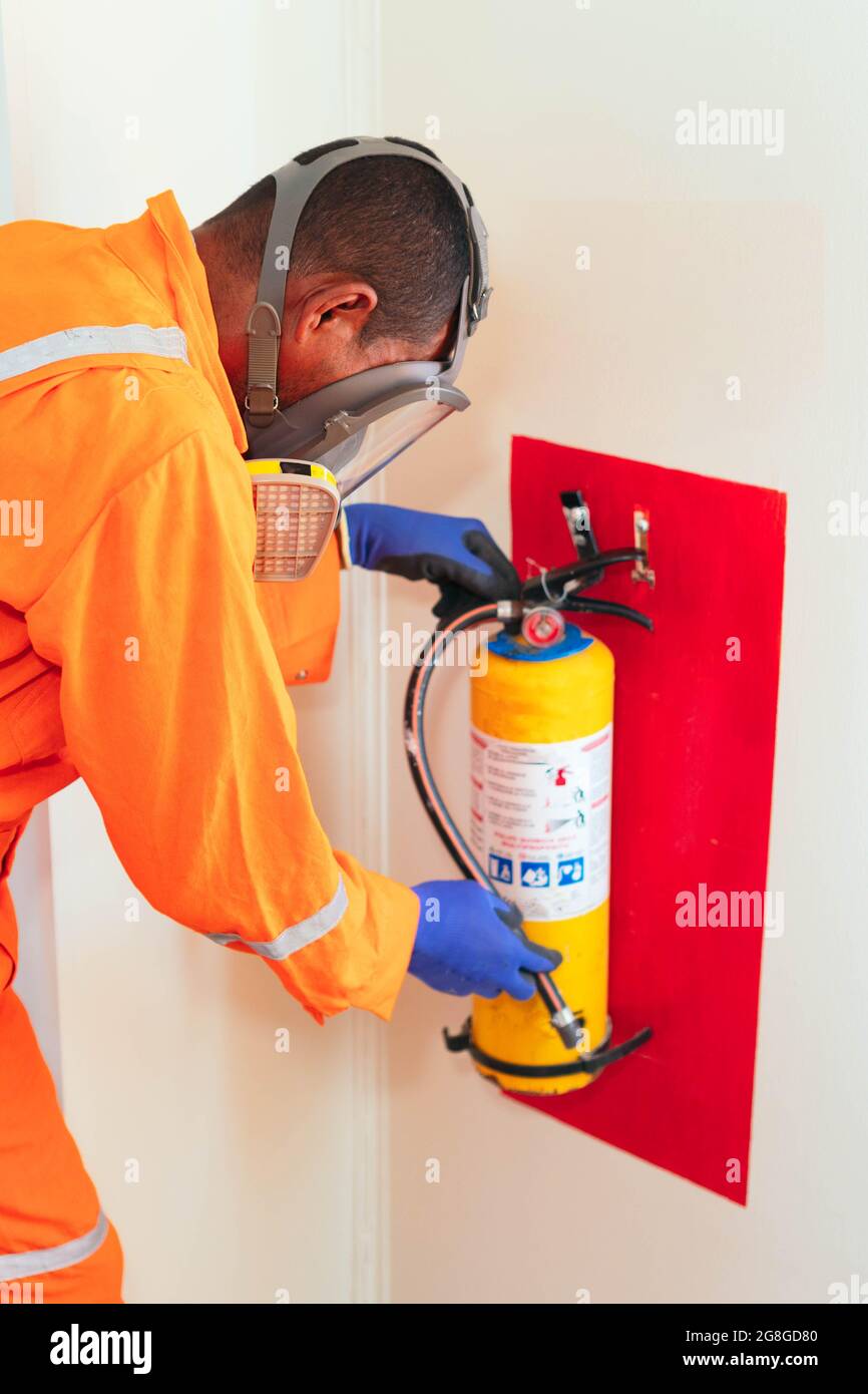 Man with gas mask holding a fire extinguisher Stock Photo - Alamy