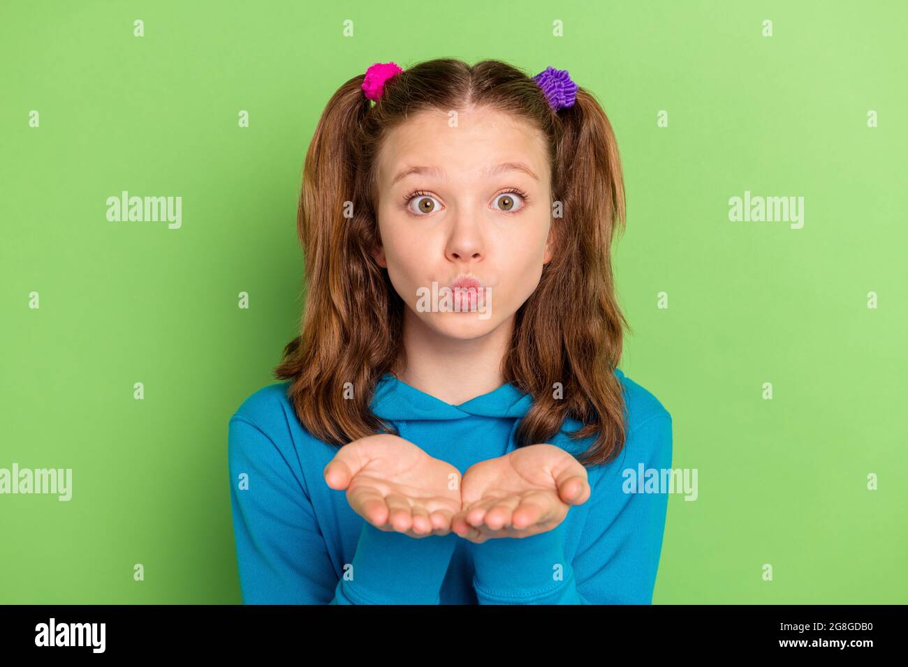 Photo of cheerful young positive small girl send air kiss you hands ...