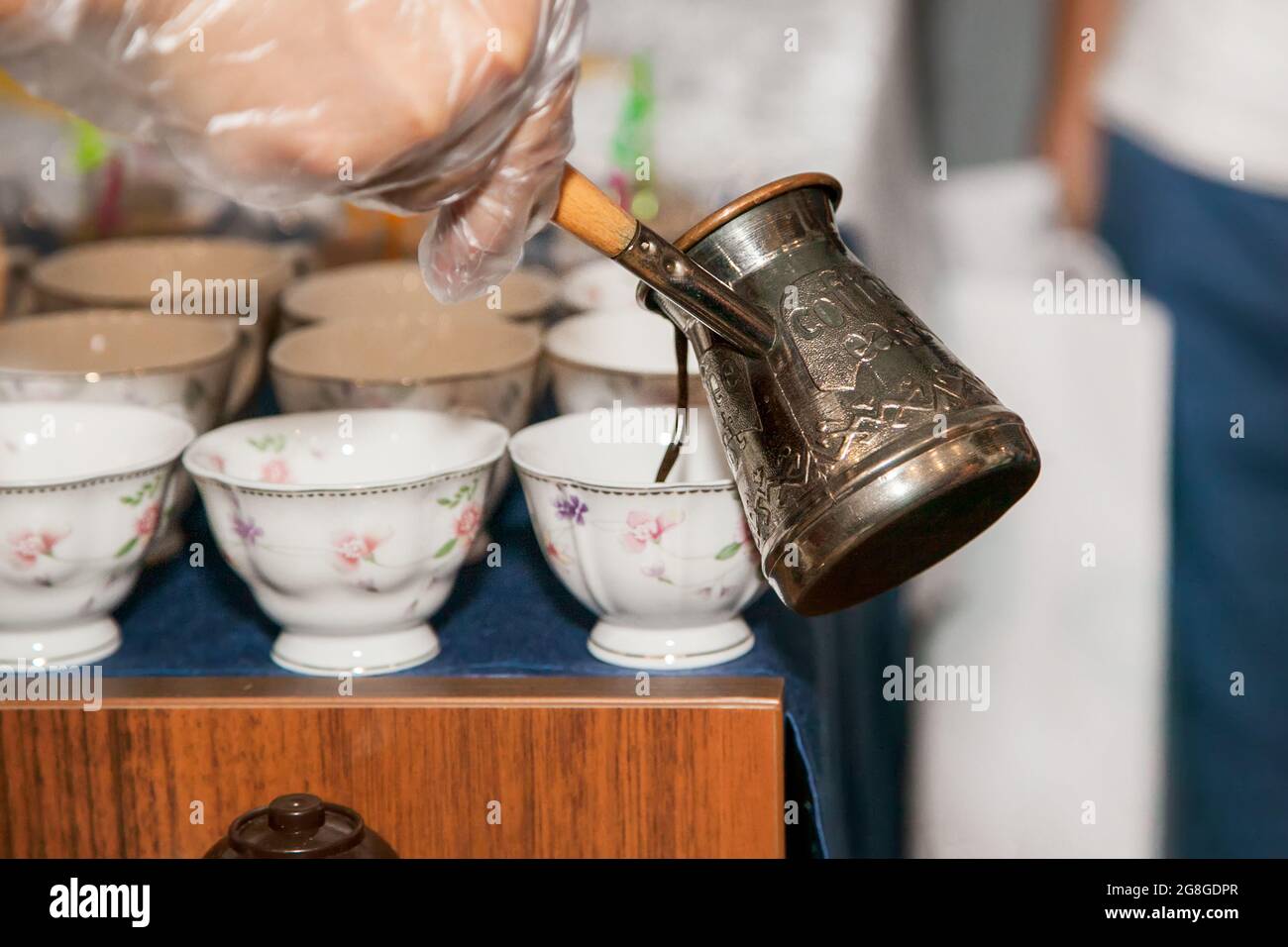 Copper cezve with Turkish coffee pouring out. Oriental, east coffee ...