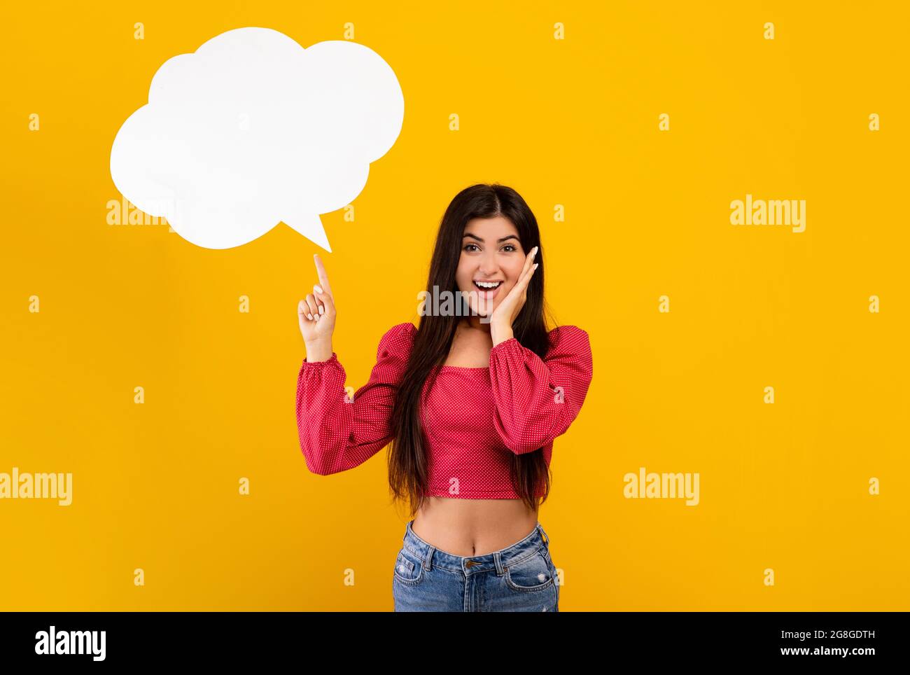 Inspired armenian lady having idea, pointing finger up at blank speech ...