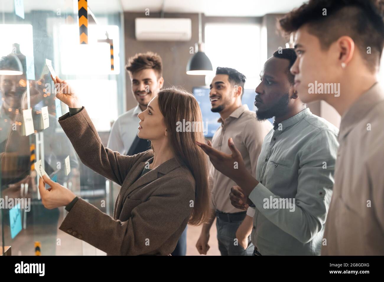 Colleagues brainstorming using sticky post-it notes at office Stock ...