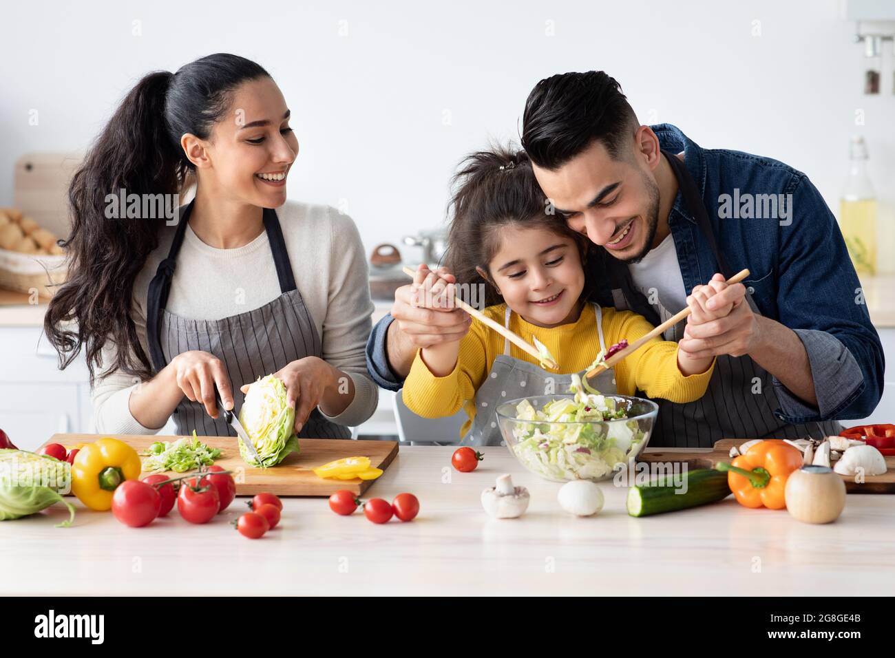 Portrait Of Cheerful Young Arab Family With Cute Little Daughter ...