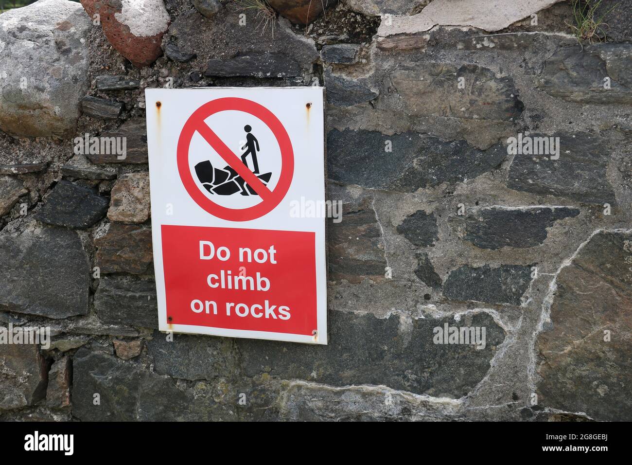 Do Not Climb on Rocks signboard situated at a coastal location Stock ...