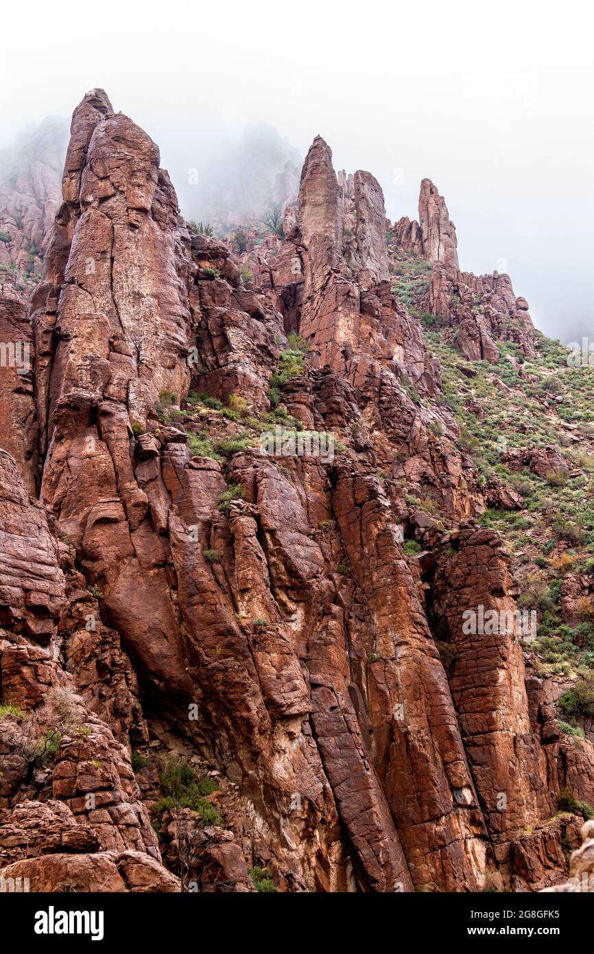 Red rock peaks outside Phoenix Arizona in the descending winter fog. US ...