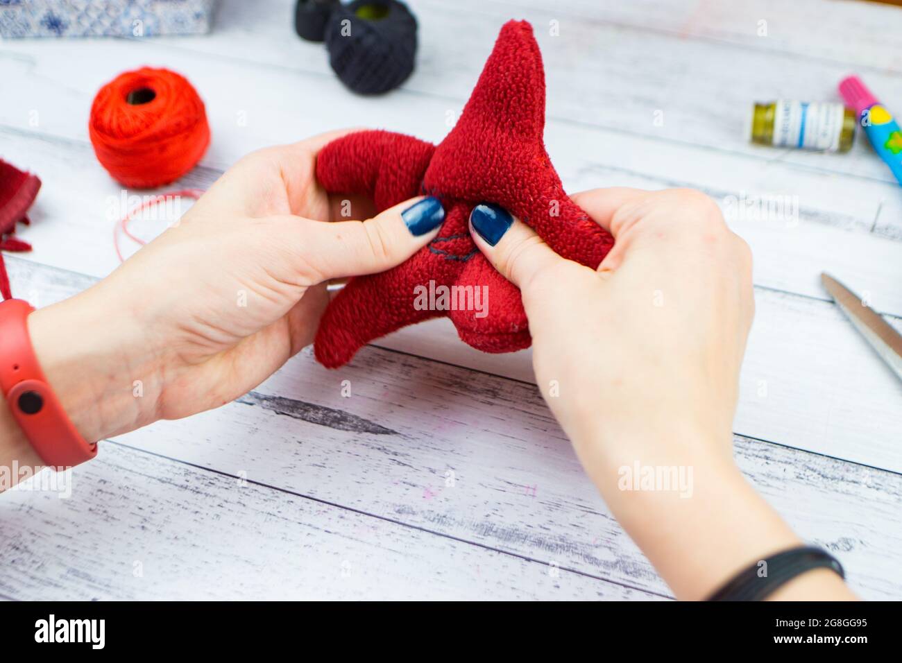 Closeup of female hands holding a star-shaped red toy Stock Photo - Alamy