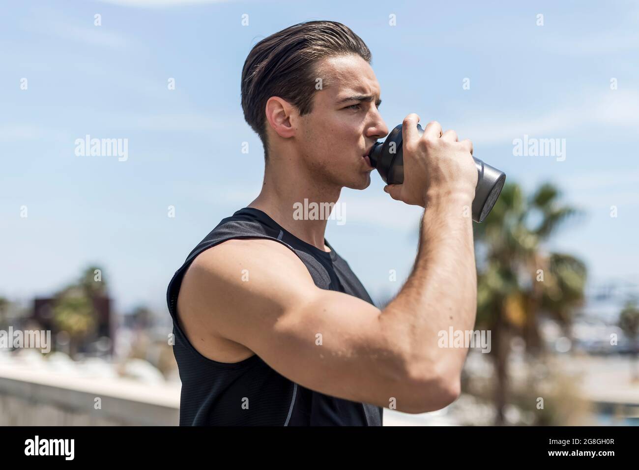 Young Man Drinking Water After Running. Portrait Stock Photo - Alamy