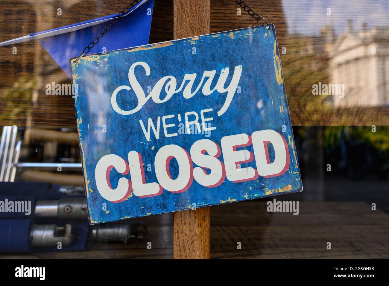 Sign in a shop window saying Sorry We're Closed Stock Photo - Alamy
