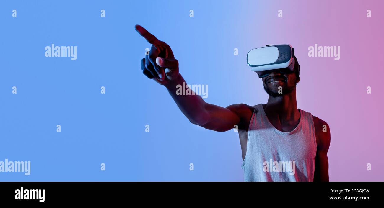Virtual reality sports. Millennial black guy in VR headset selecting ...