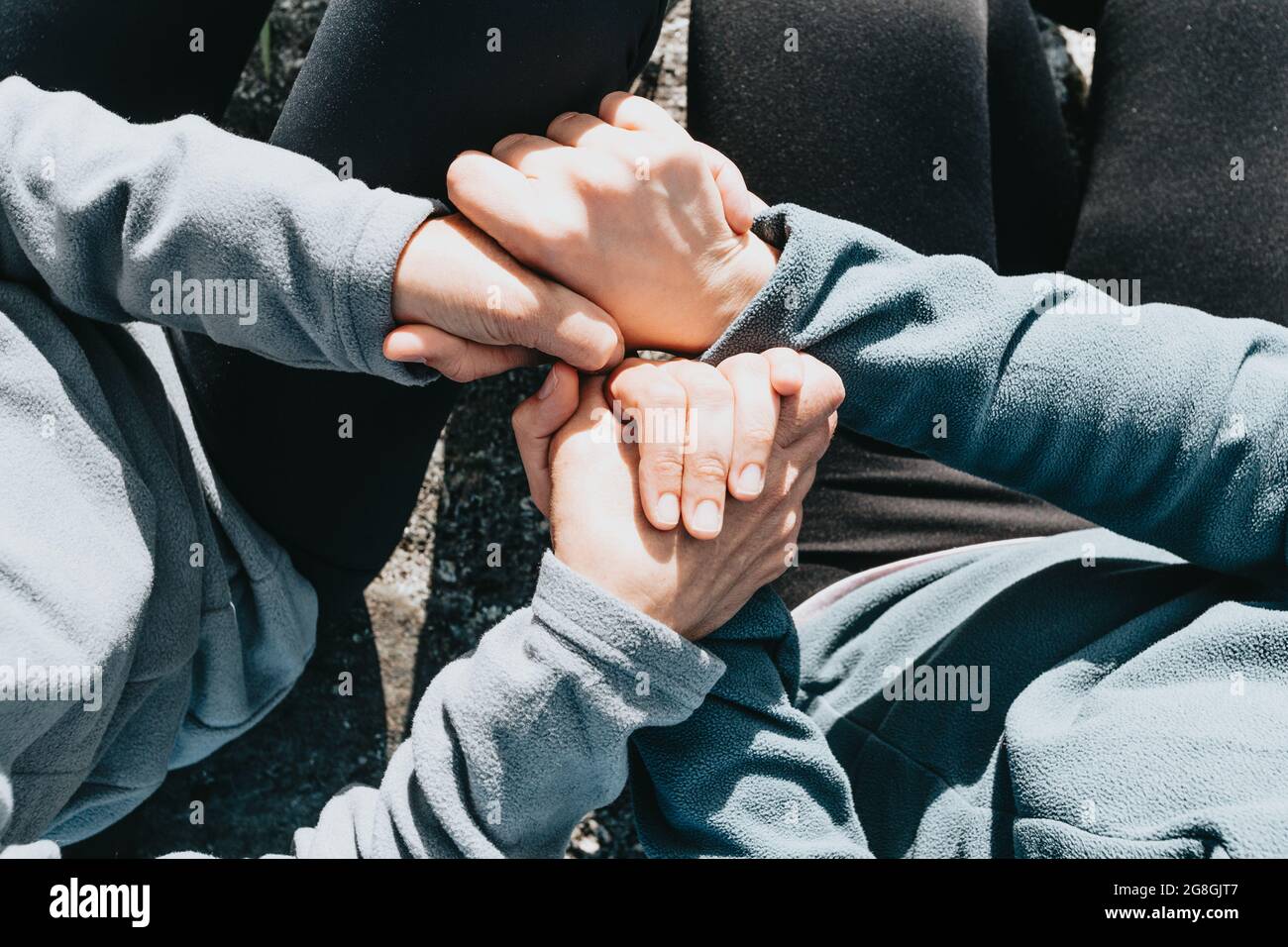 Friends holding hands together showing love and support - mental health ...