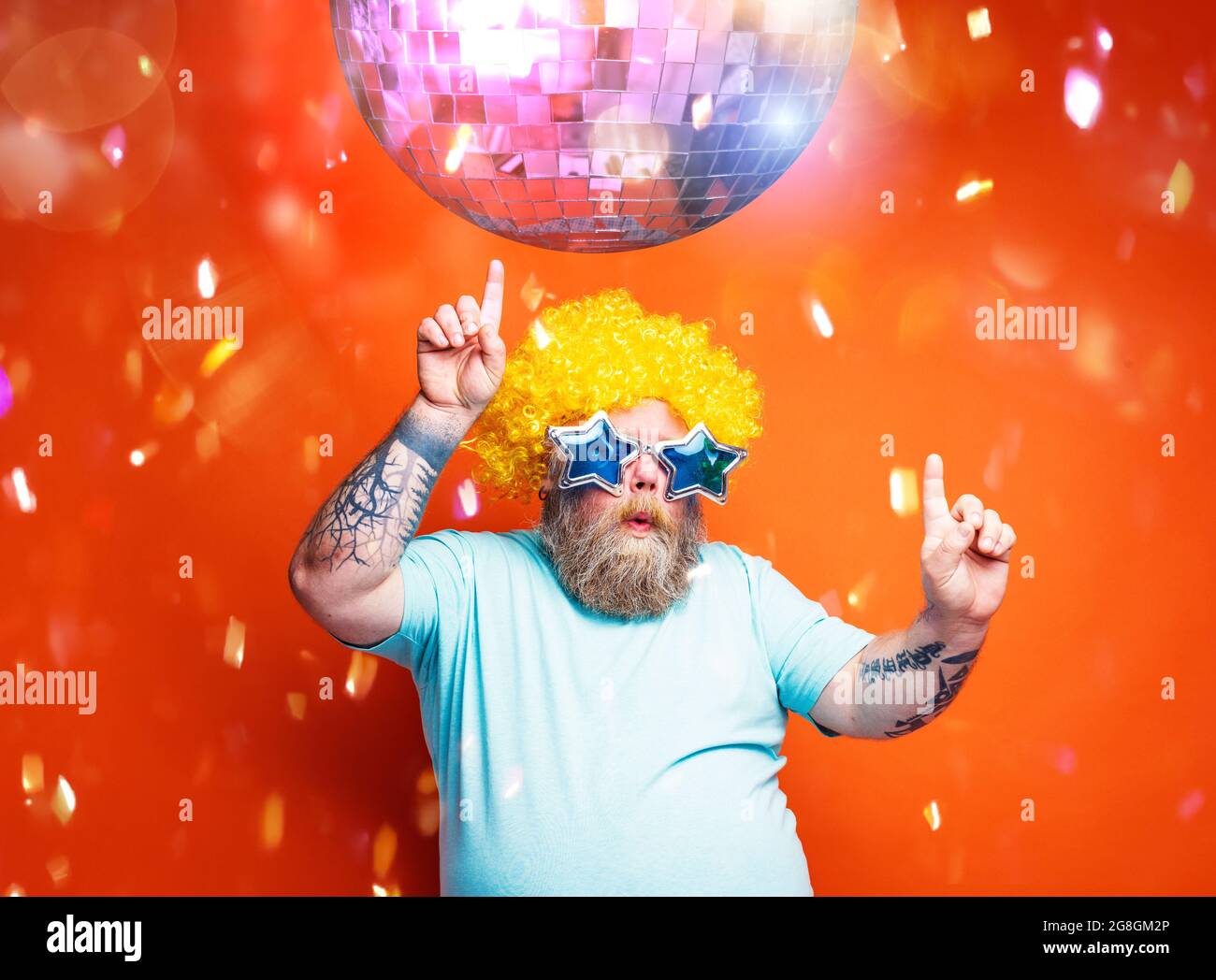 Fat man with beard, tattoos and sunglasses dances music on a disco ...