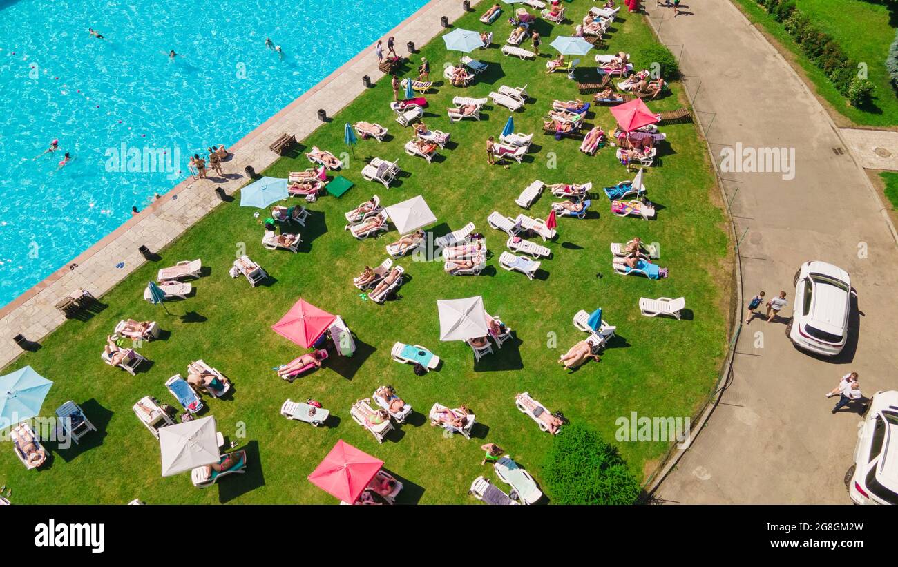aerial view of people resting sunbathing near city pool outdoors summer ...