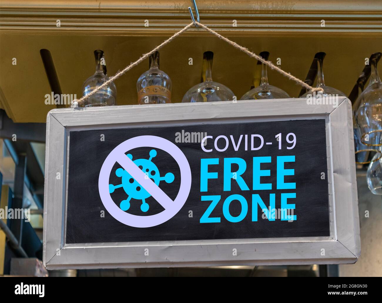 Covid free zone sign. COVID 19 FREE ZONE text label hanging, blur bar ...