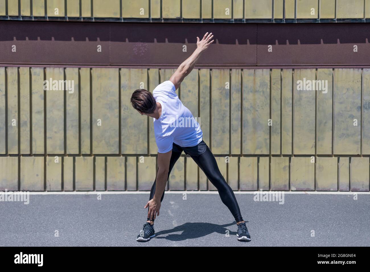 A Fit man stretching before running outdoors Stock Photo - Alamy