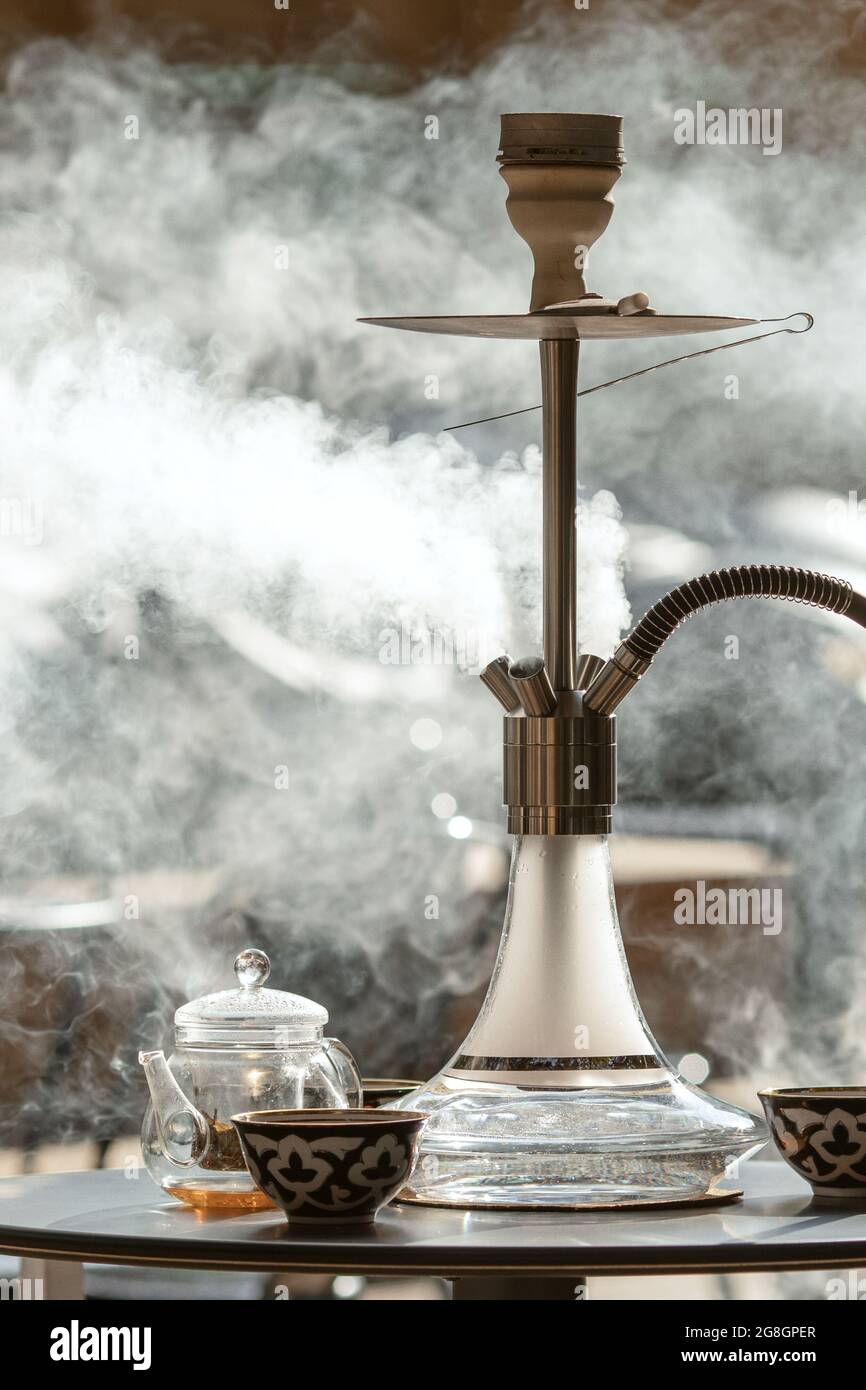 Smoking Transparent hookah on the table on the summer terrace in hookah ...