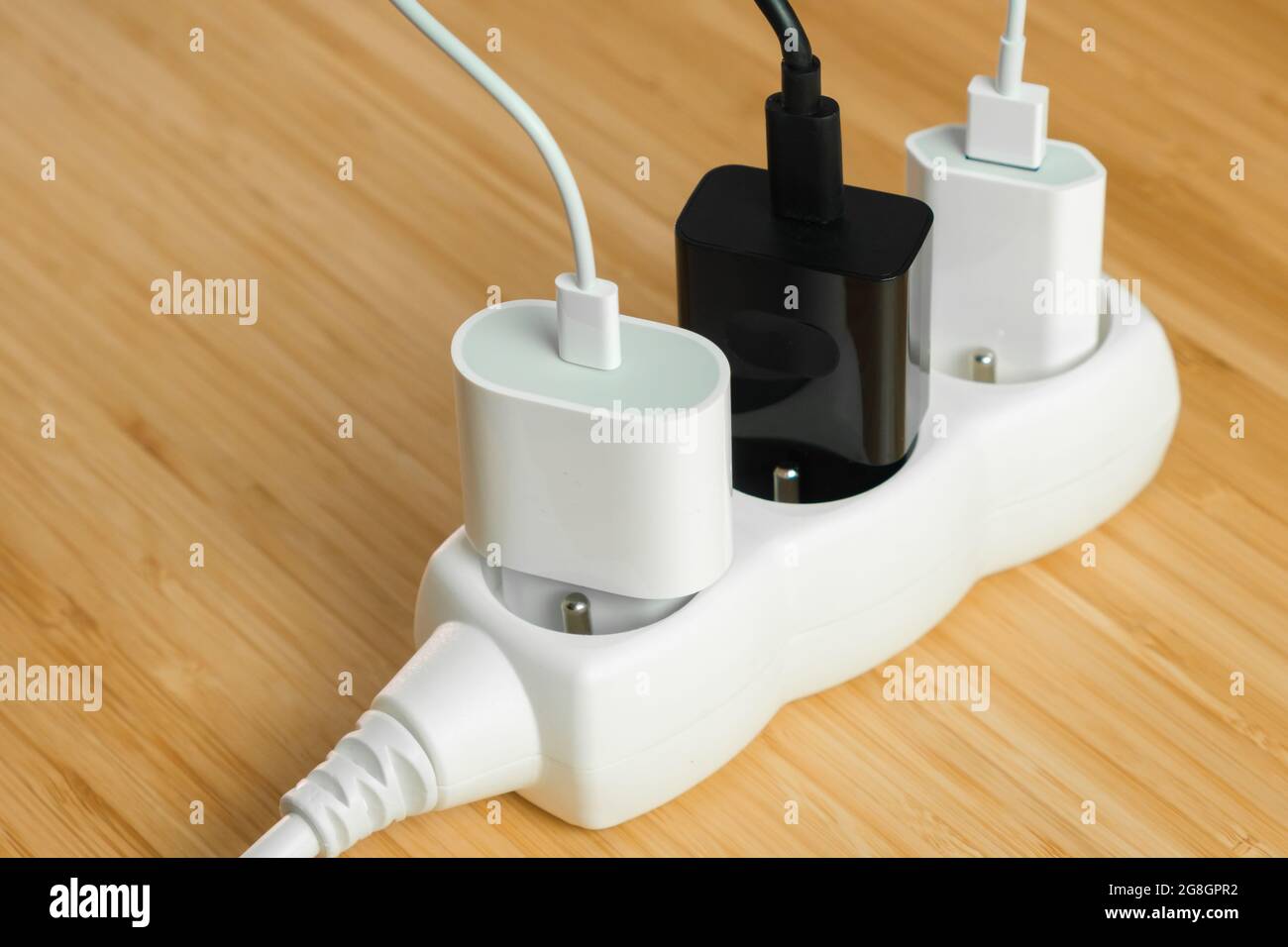 The electrical extension strip with connected white and black power ...