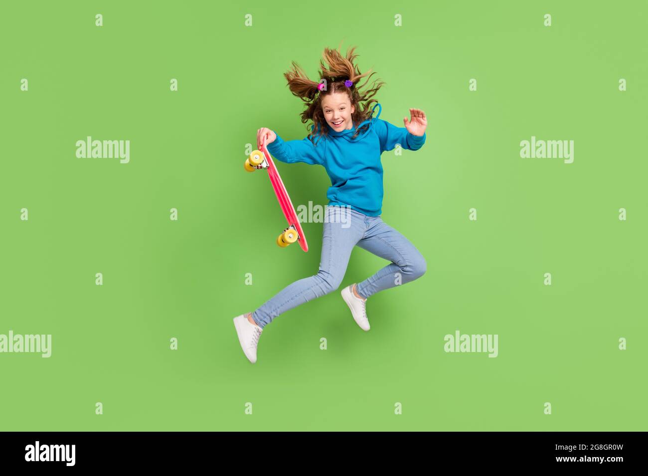 Full length photo of brunette ponytail haired girl jump wear jeans hold ...