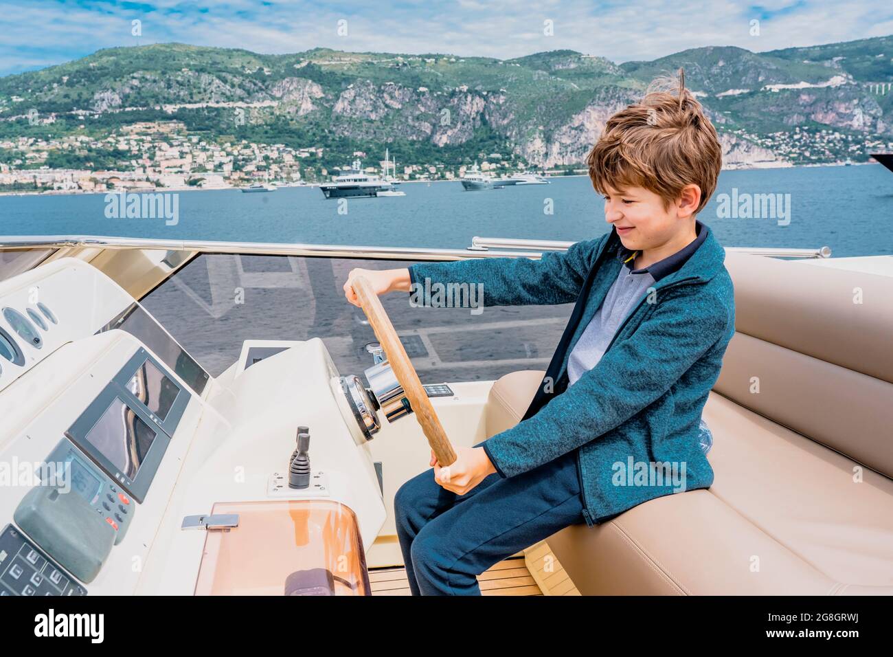 Boy driving boat hi-res stock photography and images - Alamy