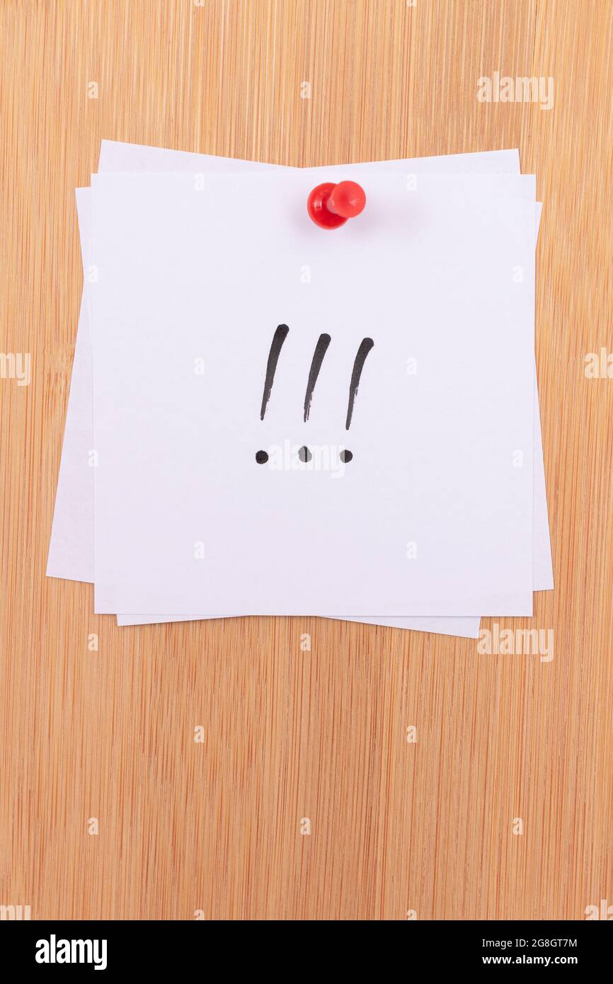 White Sticky Notes with Three Exclamation Points Pinned to the Wooden ...