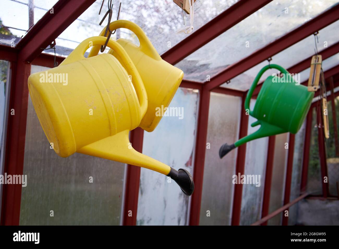 Hanging watering cans hi-res stock photography and images - Alamy