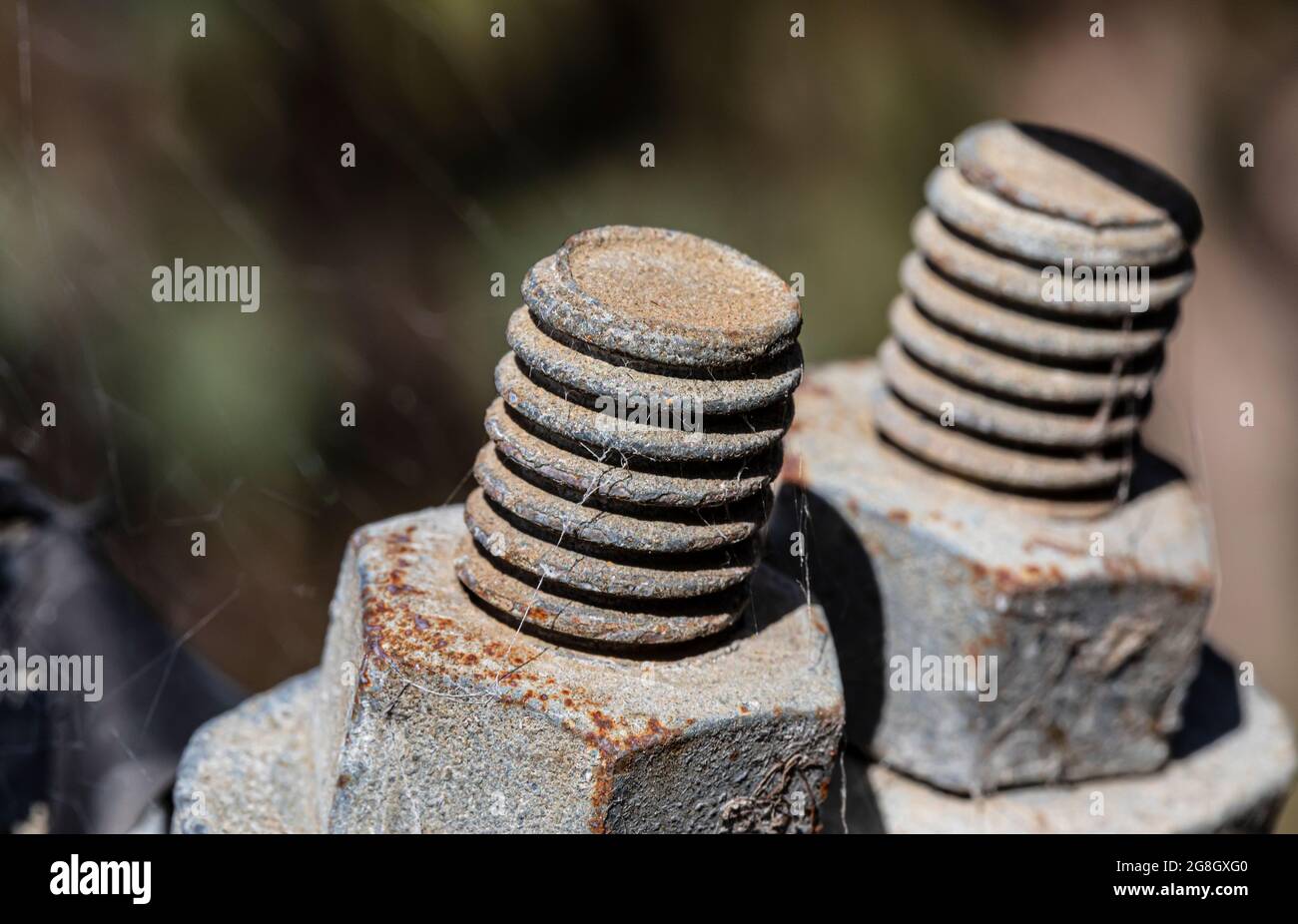 Photograph of the thread of a rusty galvanised bolt and nut securing a ...