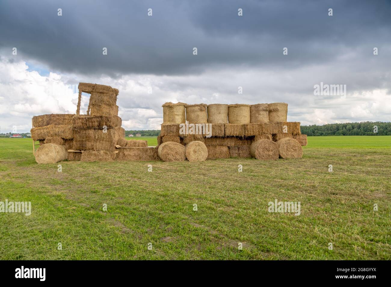 tractor from straw bales in the field Stock Photo - Alamy
