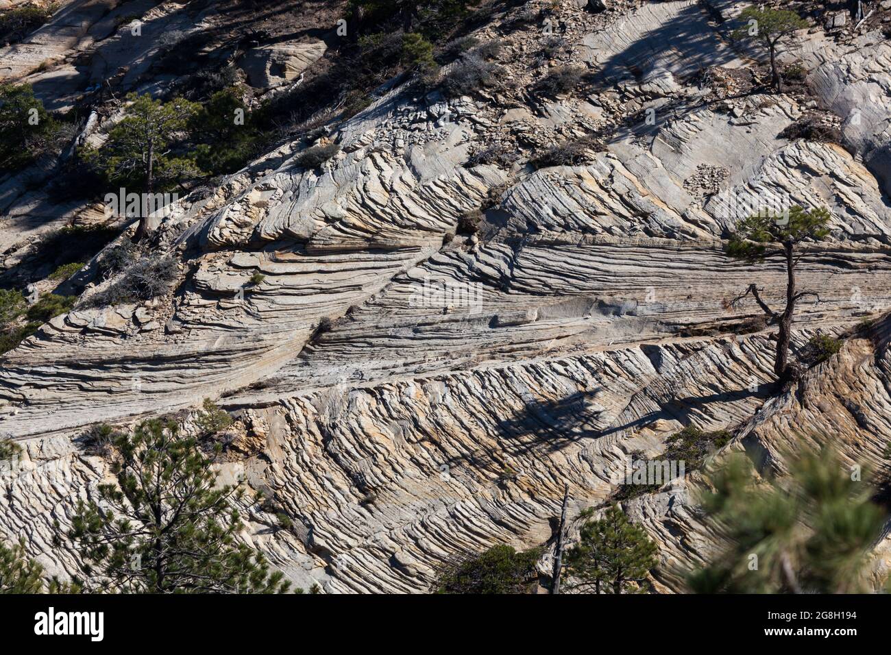 An eroded mountainside sandstone cliff with vertical and horizontal ...