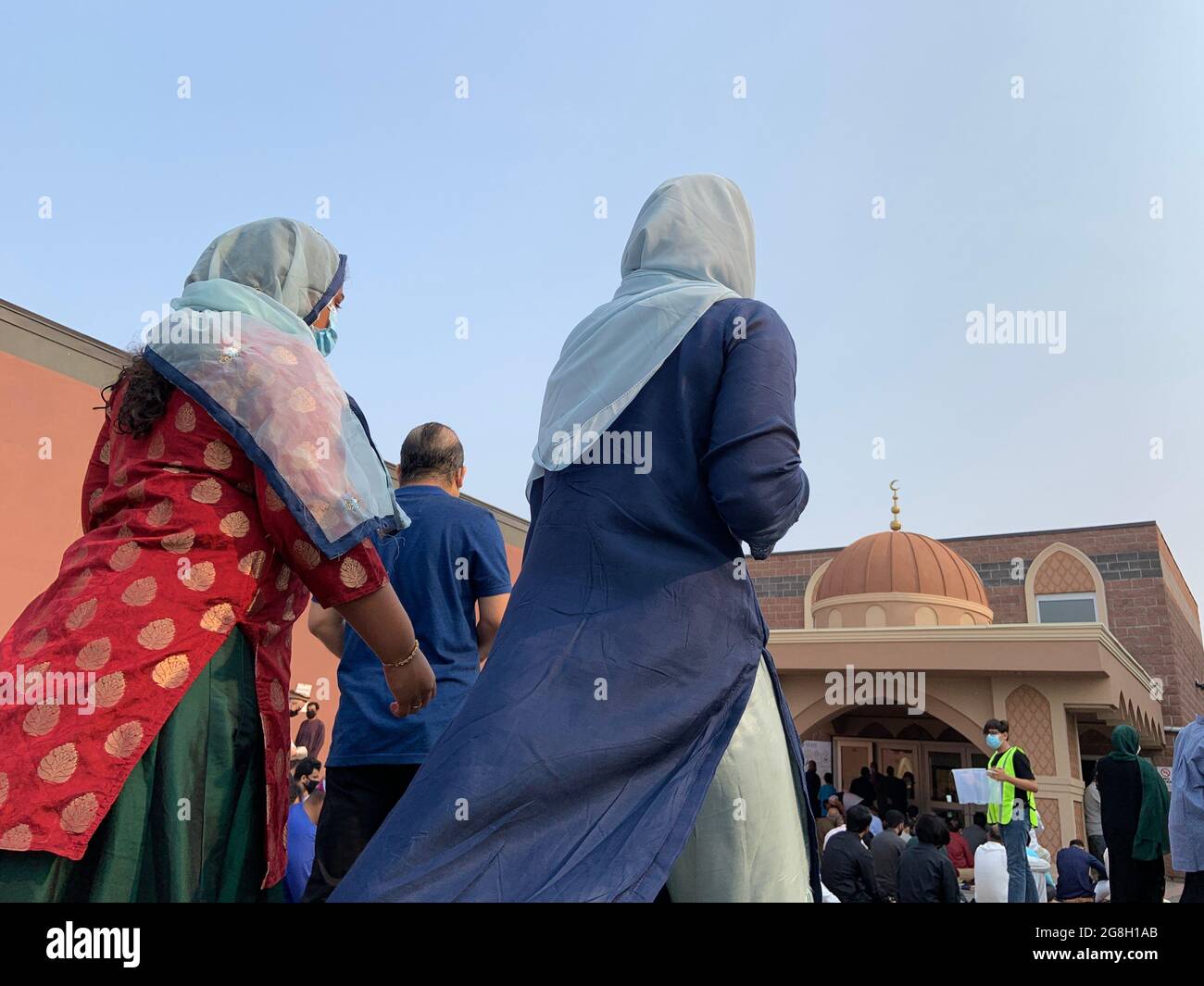 Muslim women gather along with men and children at the Hamilton ...