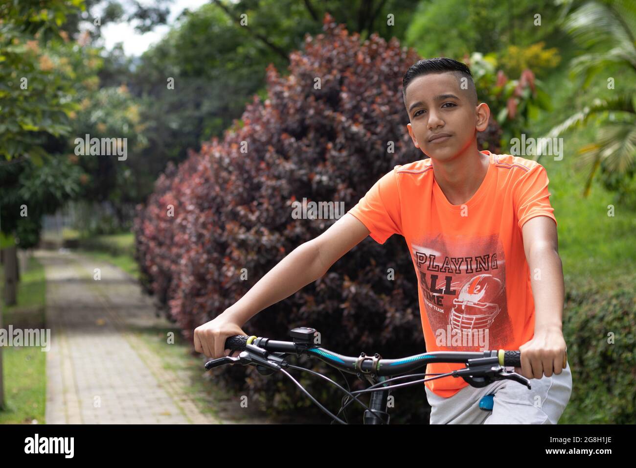 latin boy riding bicycle Stock Photo - Alamy