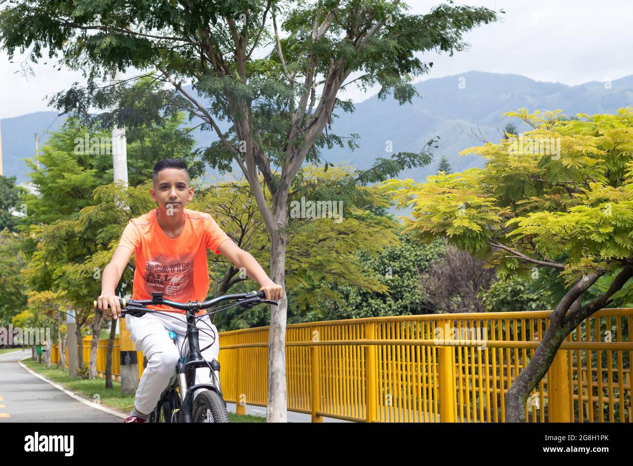 latin boy riding bicycle Stock Photo - Alamy