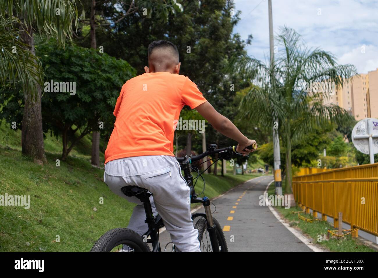 latin boy riding bicycle Stock Photo - Alamy