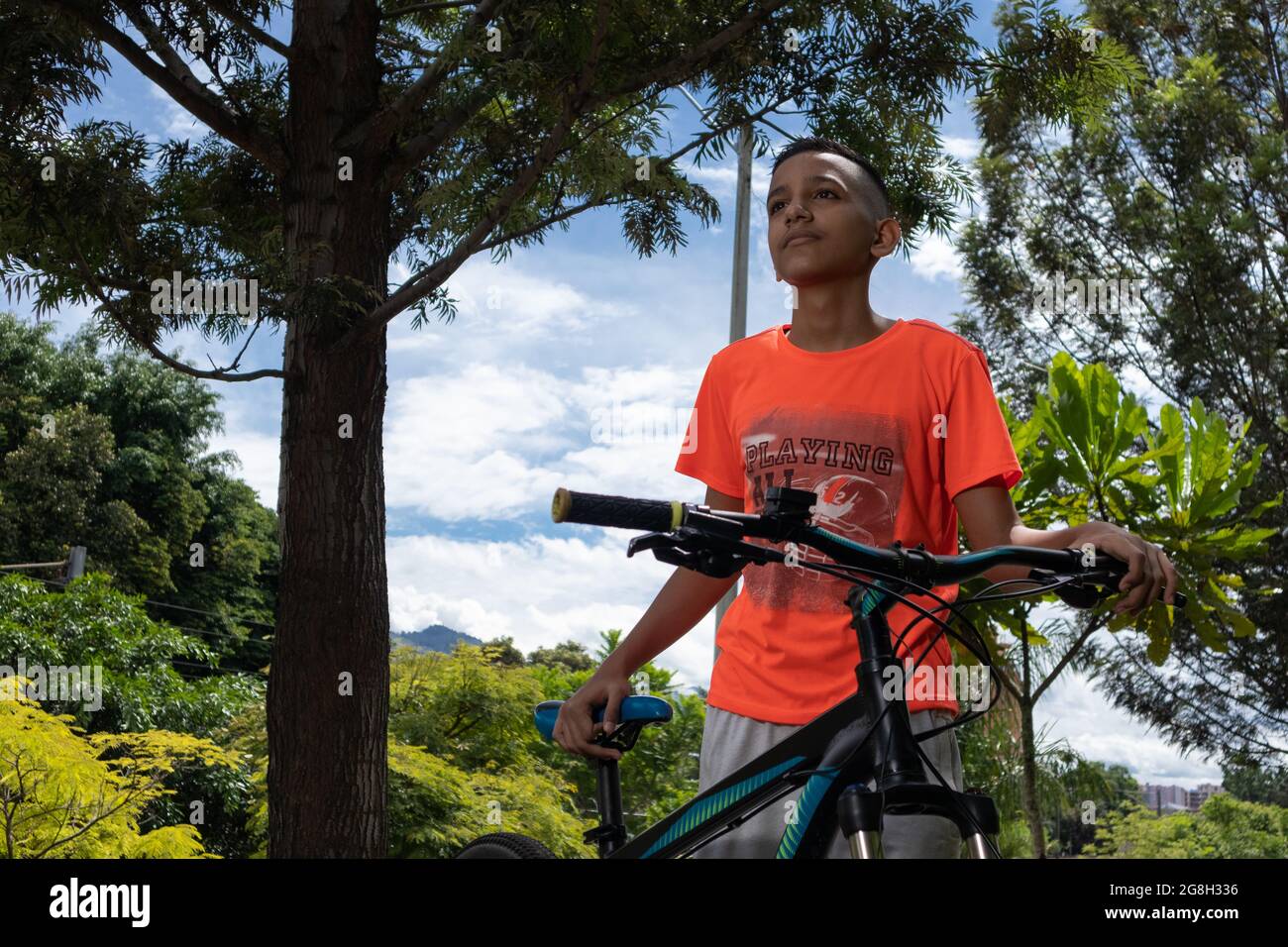 latin boy riding bicycle Stock Photo - Alamy