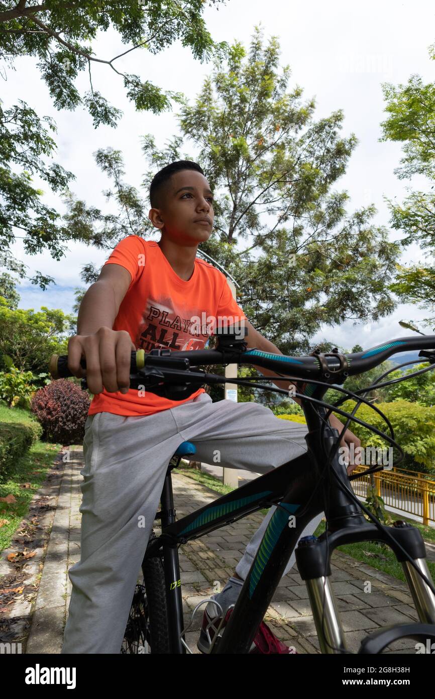 latin boy riding bicycle Stock Photo - Alamy