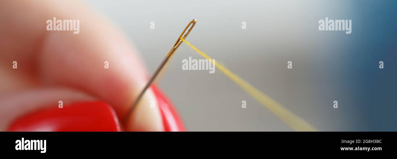 Thread needle finger hi-res stock photography and images - Alamy