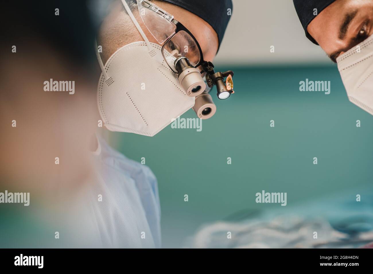 Medical surgeon team operating patient in surgical room at private ...