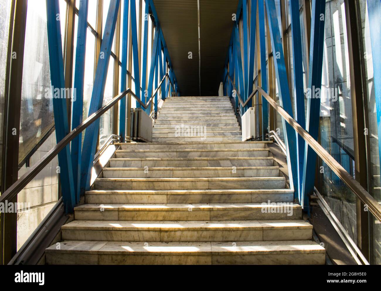 Staircase in a glass cage. Bridge connecting two buildings. Marble ...
