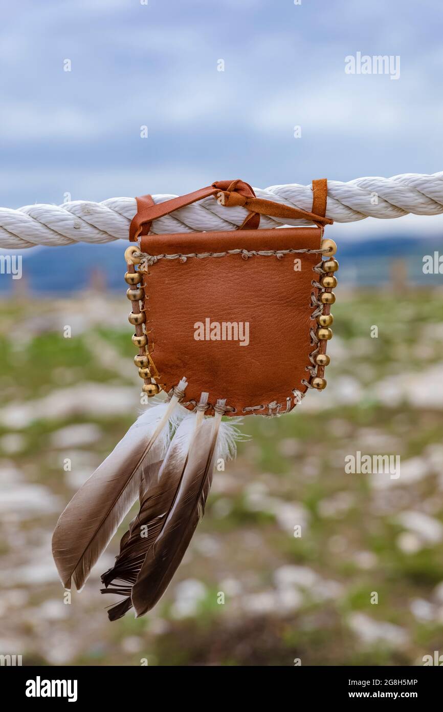 Prayer offering of pouch and feathers left by Native Americans at the ...