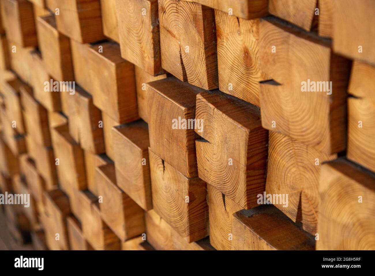 Wooden, textured wall lined with wooden cubes, longitudinal cuts of a ...