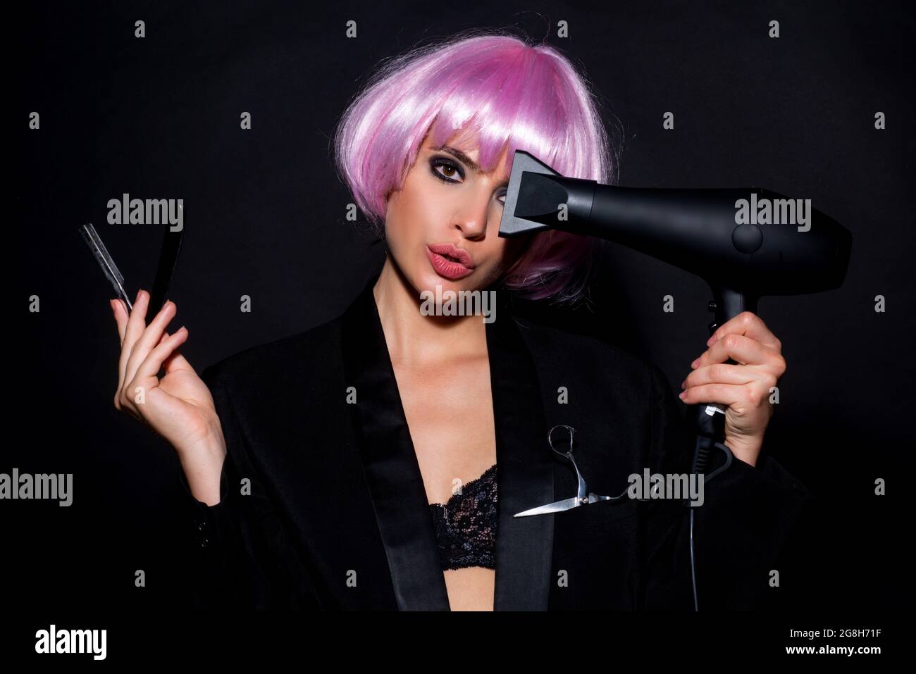 Fashion woman with hair dryer and razor blade. Vogue girl with straight ...