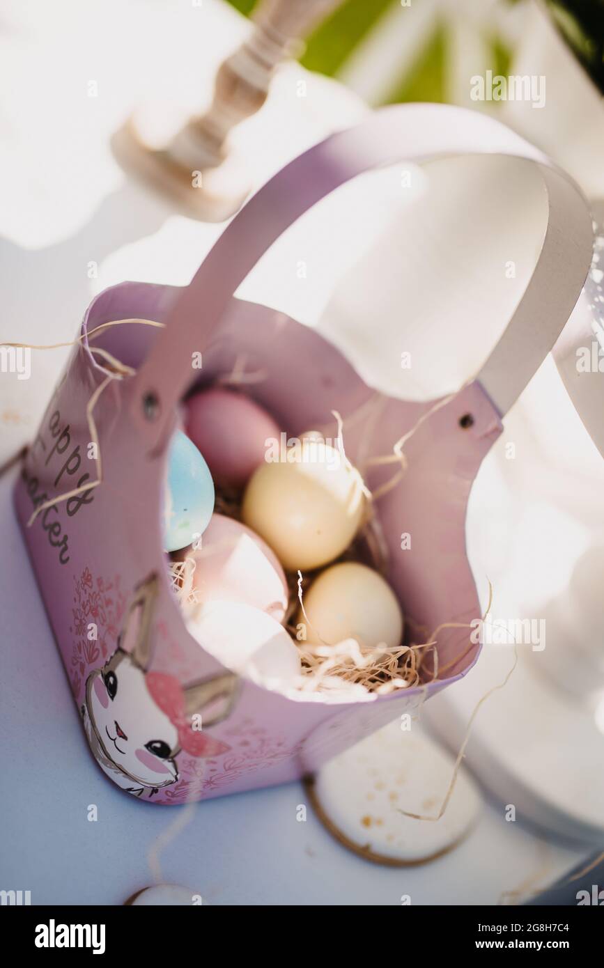 Vertical closeup shot of a basket with colorful Easter eggs Stock Photo ...