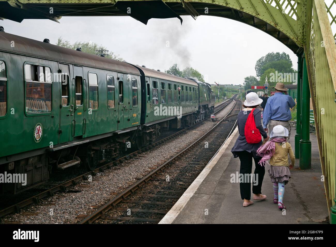 Steam train on the platform of Corfe Castle train station with ...