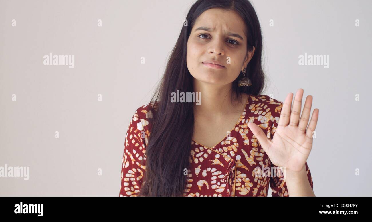Young Indian female showing denial gesture isolated on background of a ...