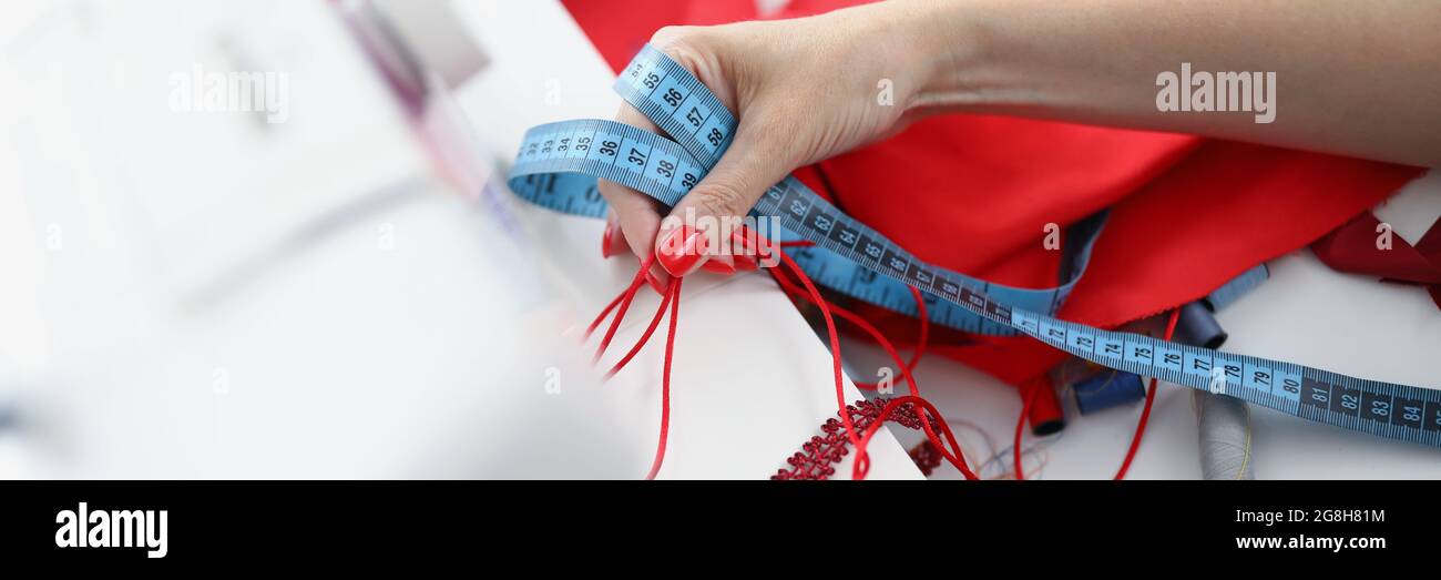 The seamstress holds samples for sewing product Stock Photo - Alamy