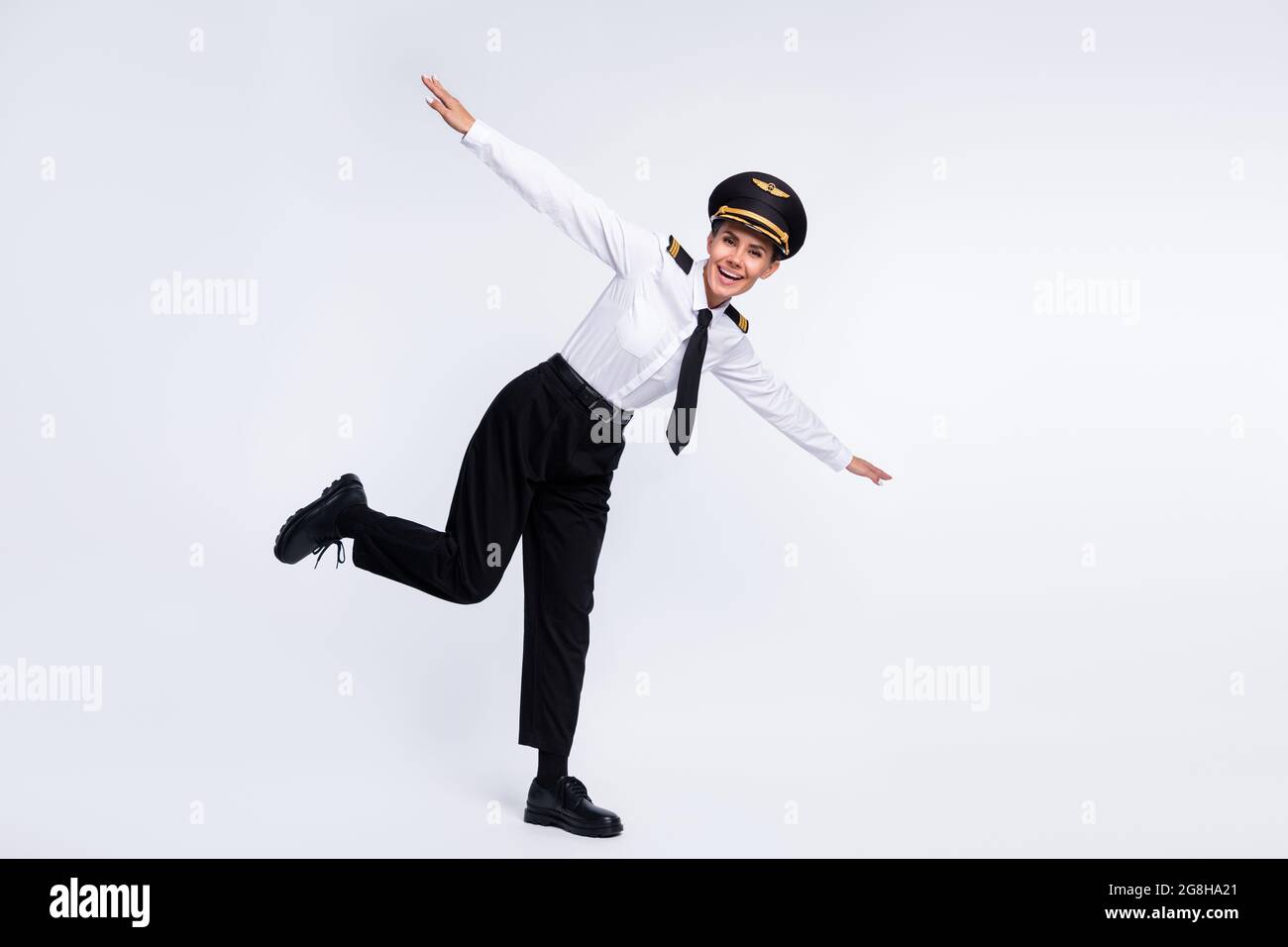 Photo of funny crazy lady plane pose arms wings wear hat aviator ...