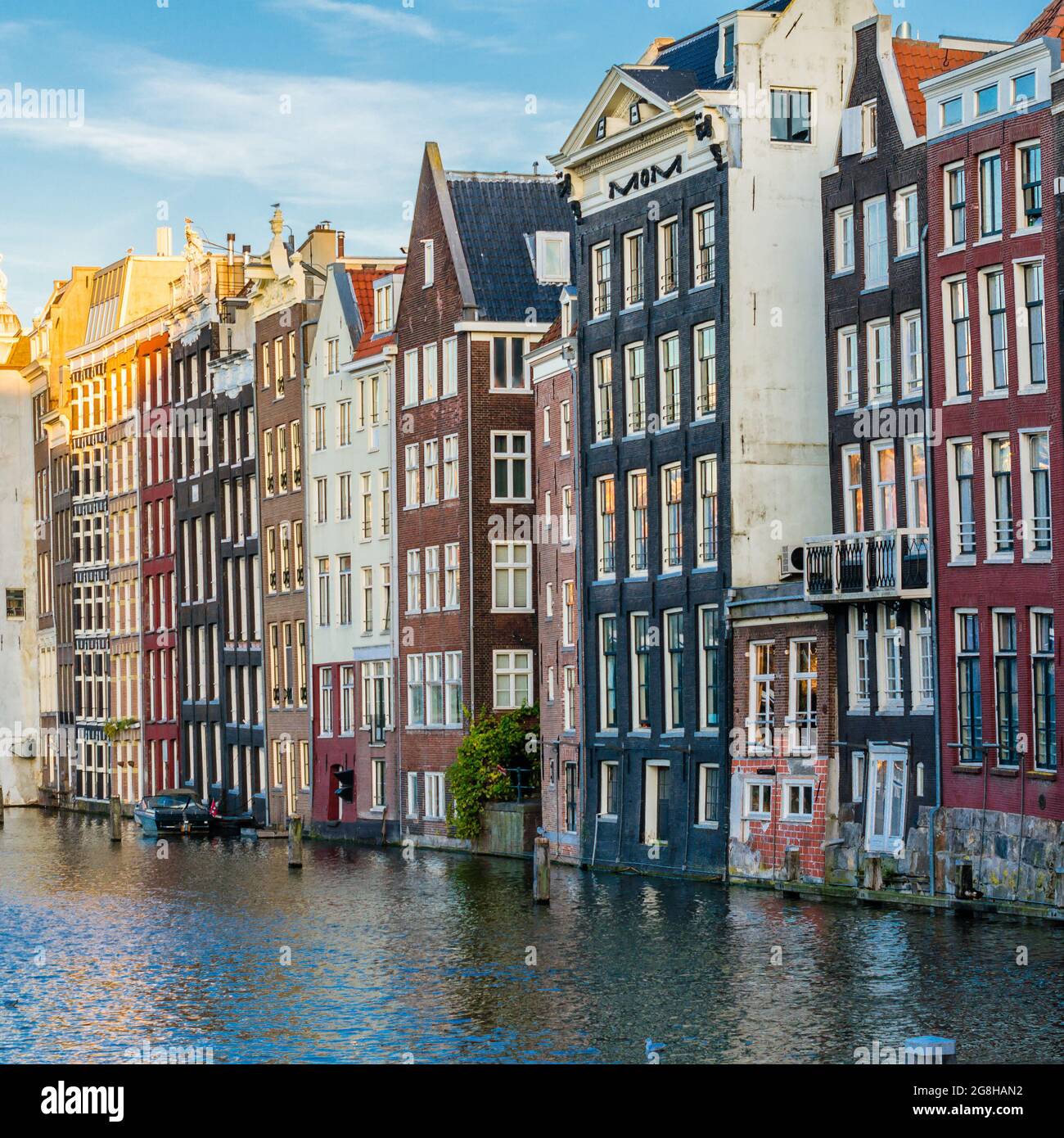 Colorful houses along the canal and their reflection in the water in ...