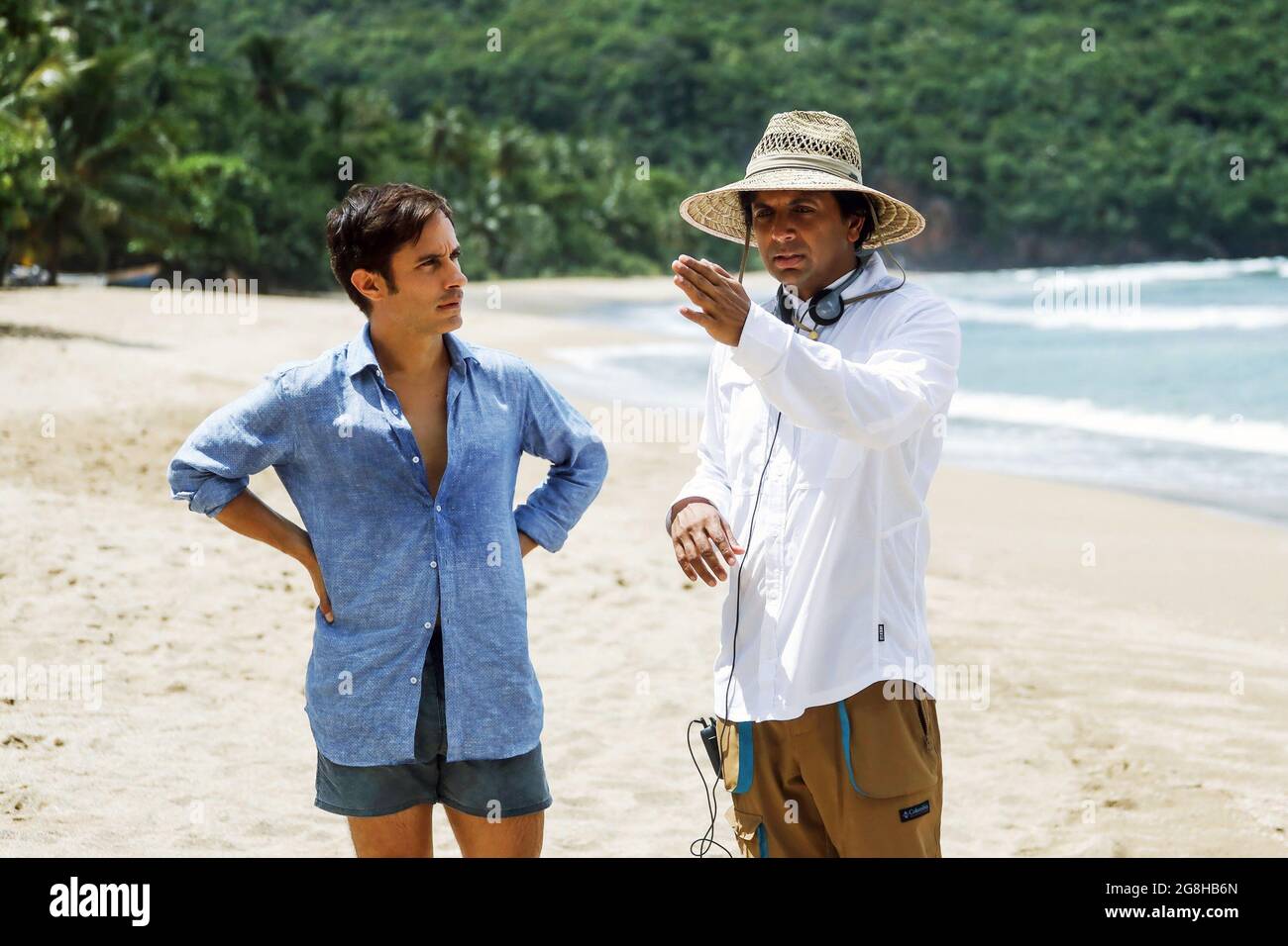 OLD, from left: Gael García Bernal, director M. Night Shyamalan, on set, 2021. ph: Phobymo ...