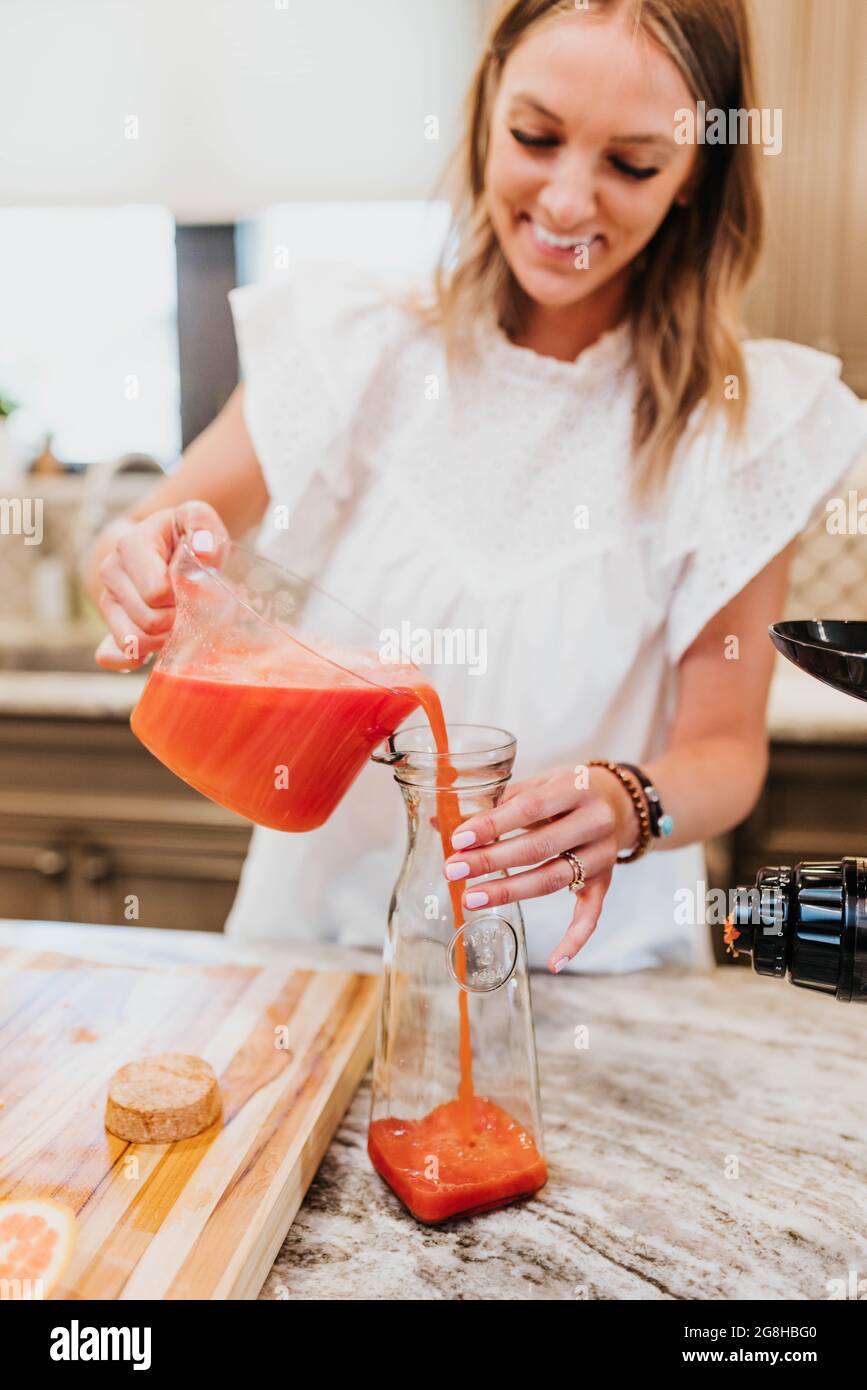 Woman pours orange juice glass hi-res stock photography and images - Alamy